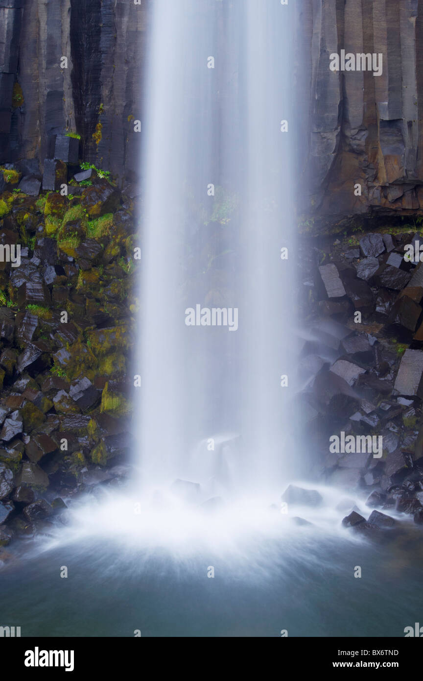 Water tumbling upon black basalt columns at famous Svartifoss waterfall ...