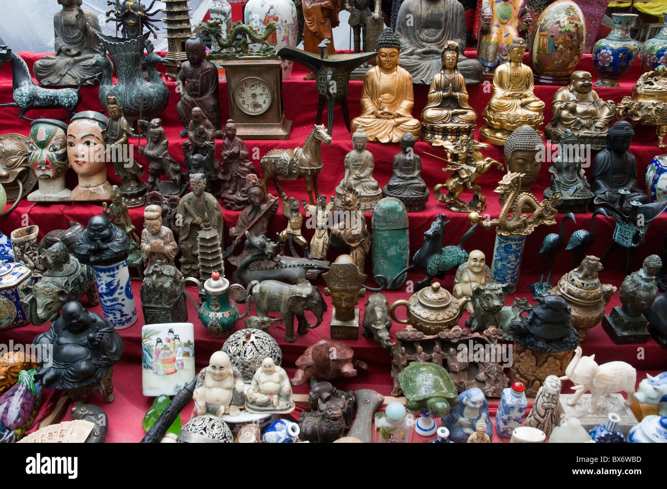 Buddha statues and ornaments for sale at a street market stall in ...