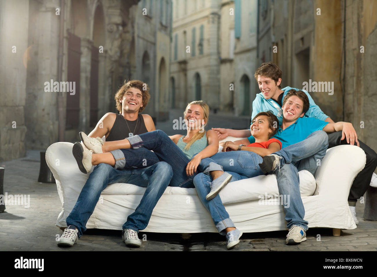 Group relax on couch laughing in street Stock Photo - Alamy