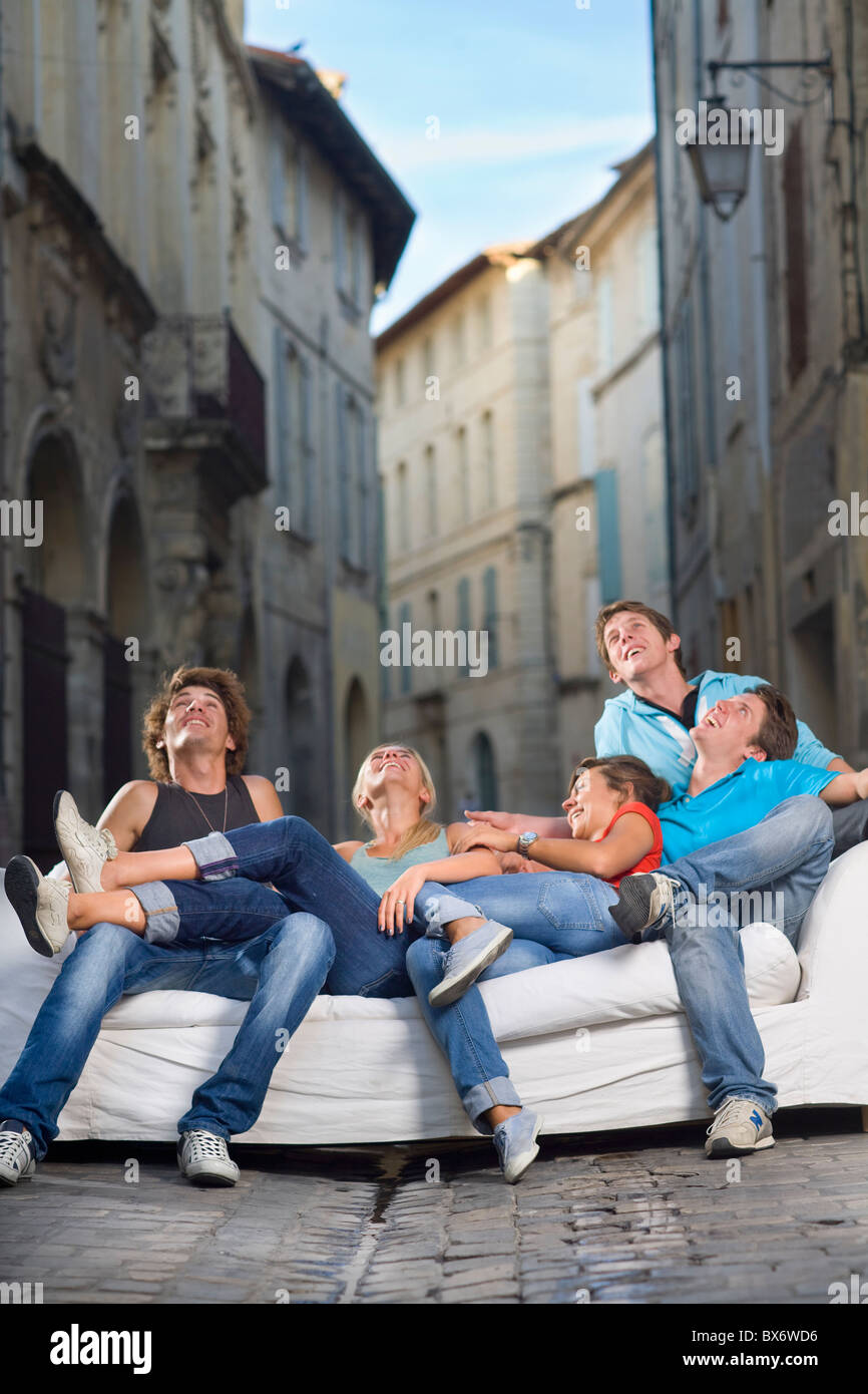 Group look up sitting on couch in street Stock Photo - Alamy