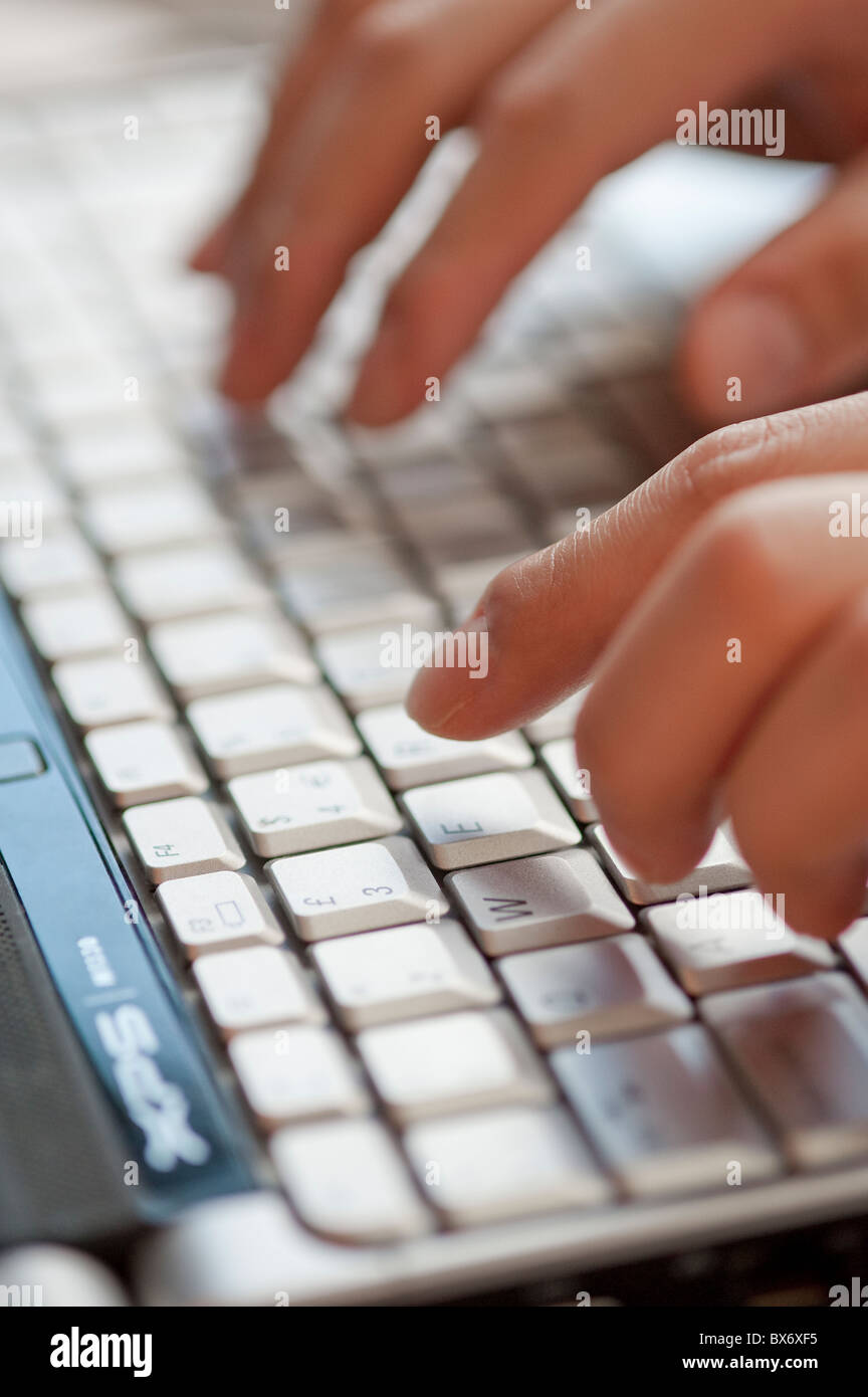 A closeup of fingers typing on laptop keyboard in a modern office Stock ...