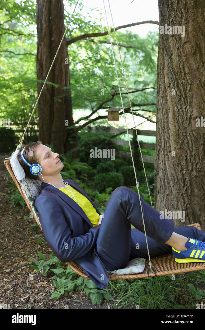 Young man relaxing in hammock Stock Photo - Alamy
