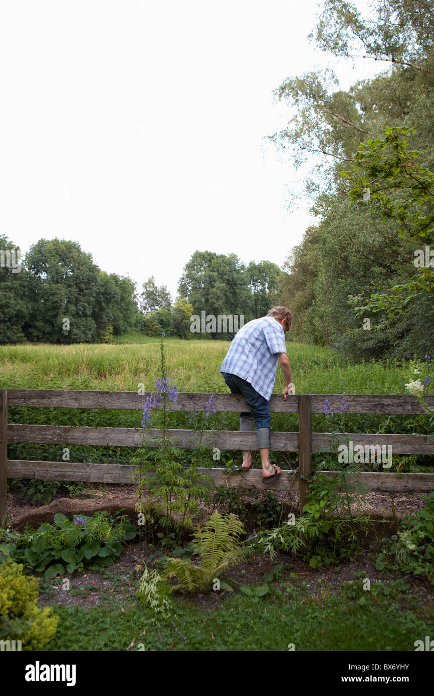 Climbing over fence hi-res stock photography and images - Alamy