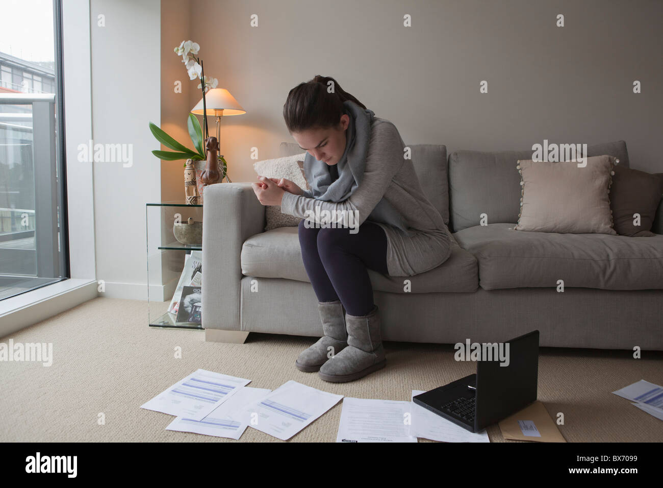 Young woman looking at paperwork Stock Photo - Alamy