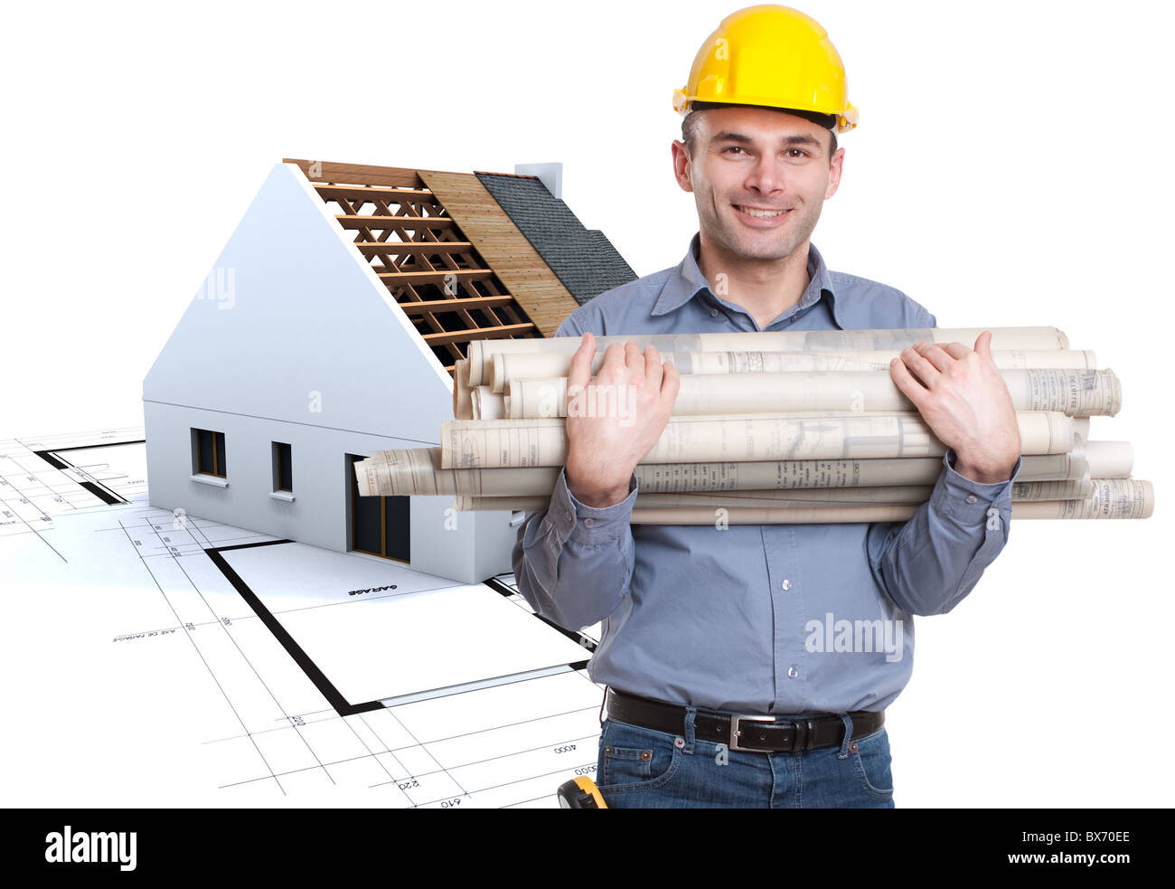 Young architect holding lots of blueprints with a house on construction ...