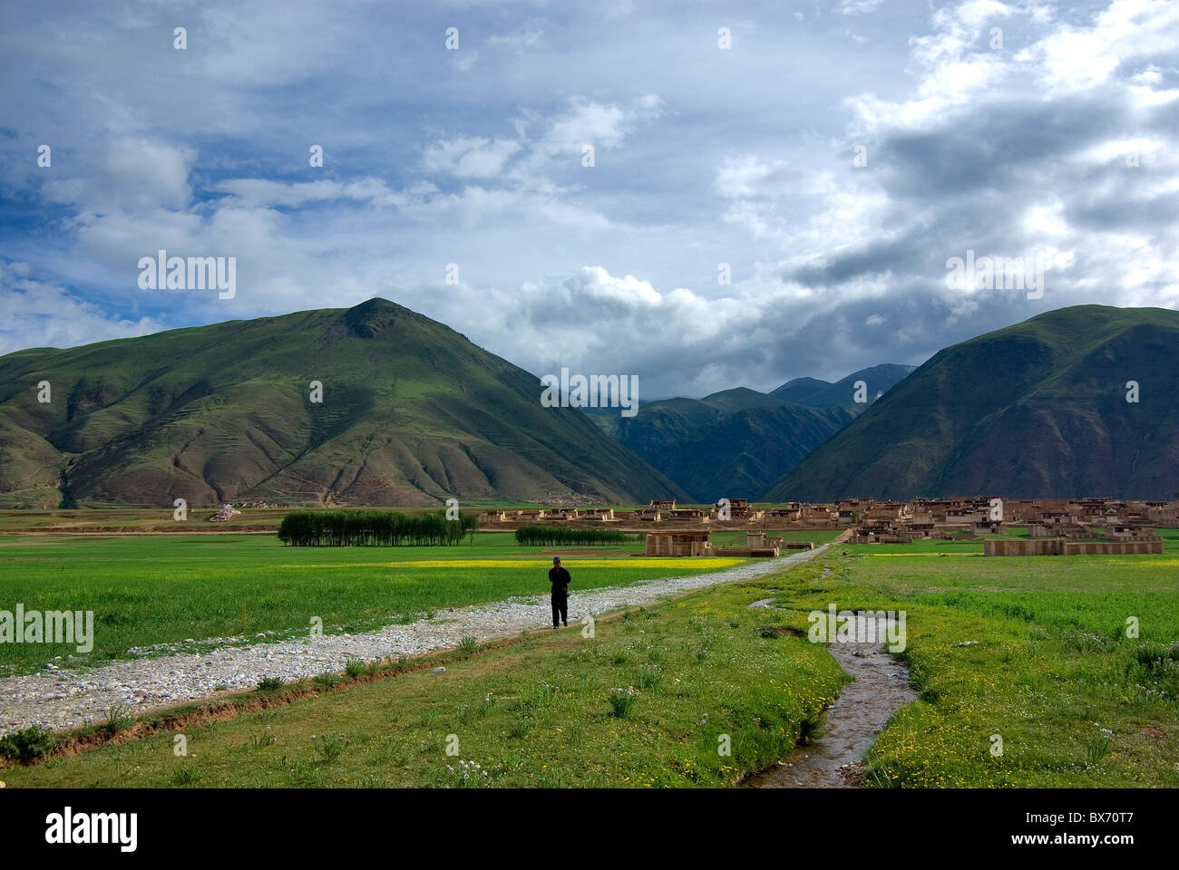 Tibetan man in front of his mountain town,sichuan,china Stock Photo - Alamy