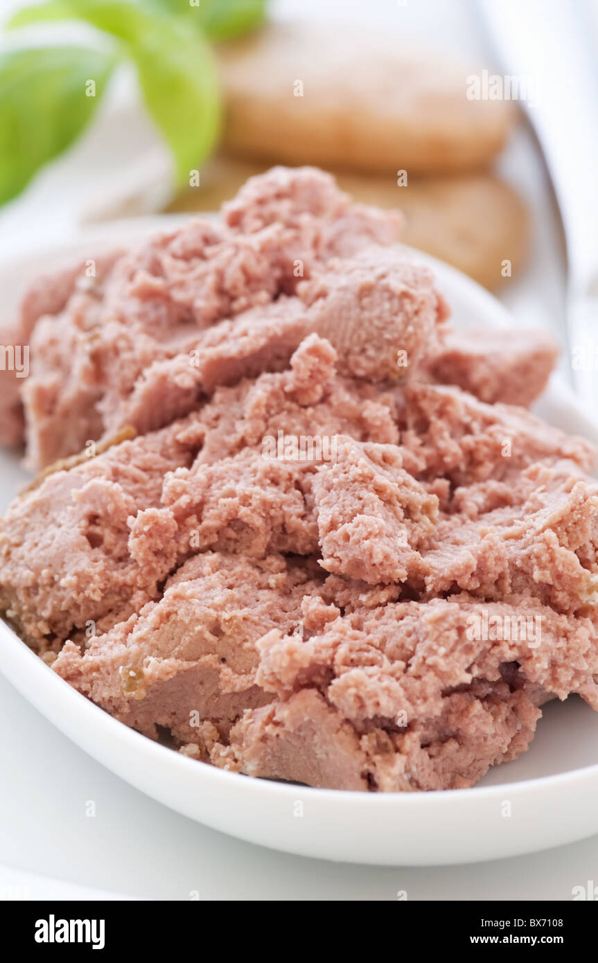 Meat paste with cracker as closeup on white background Stock Photo - Alamy