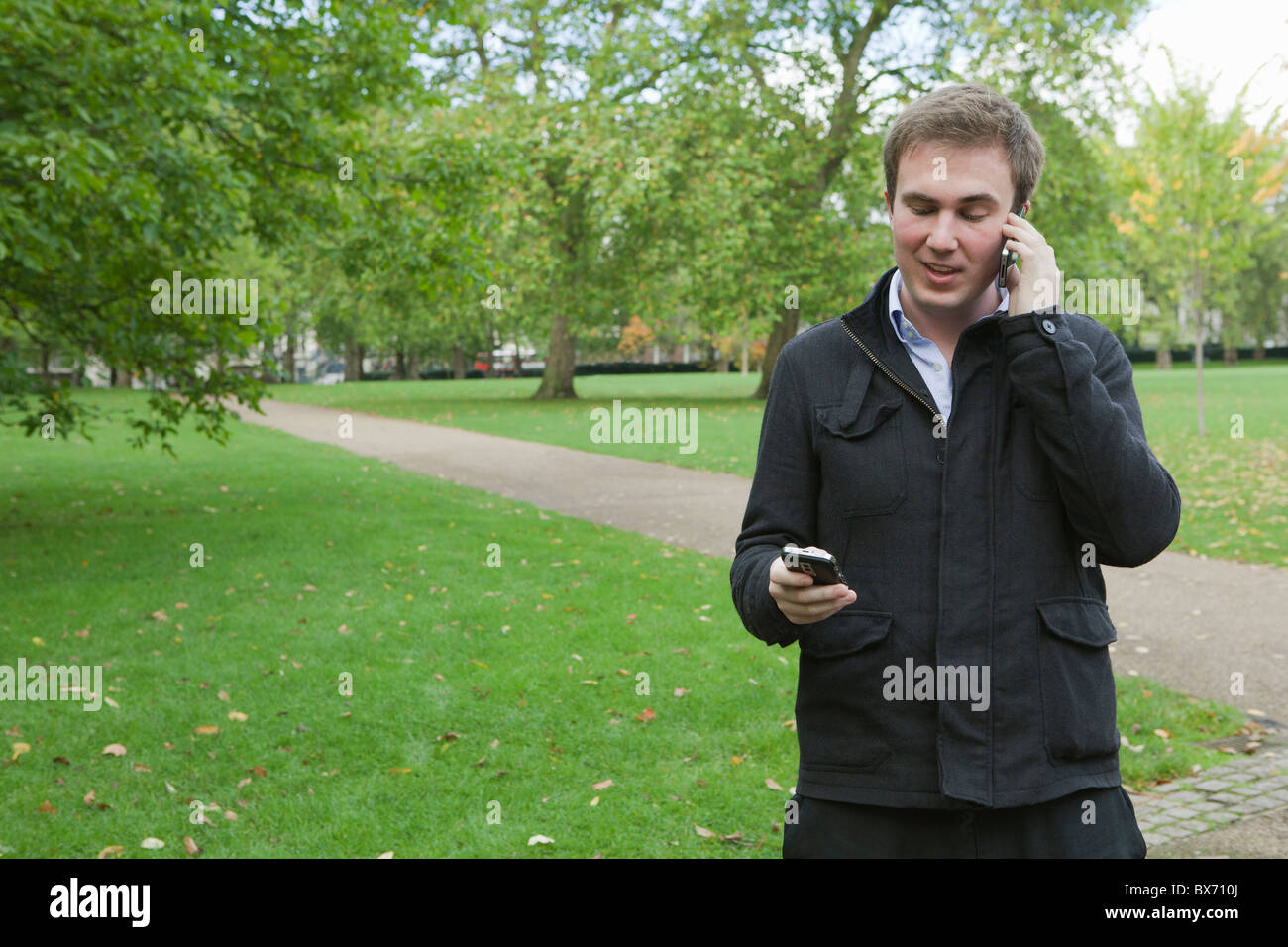 Man using two mobile phones Stock Photo - Alamy