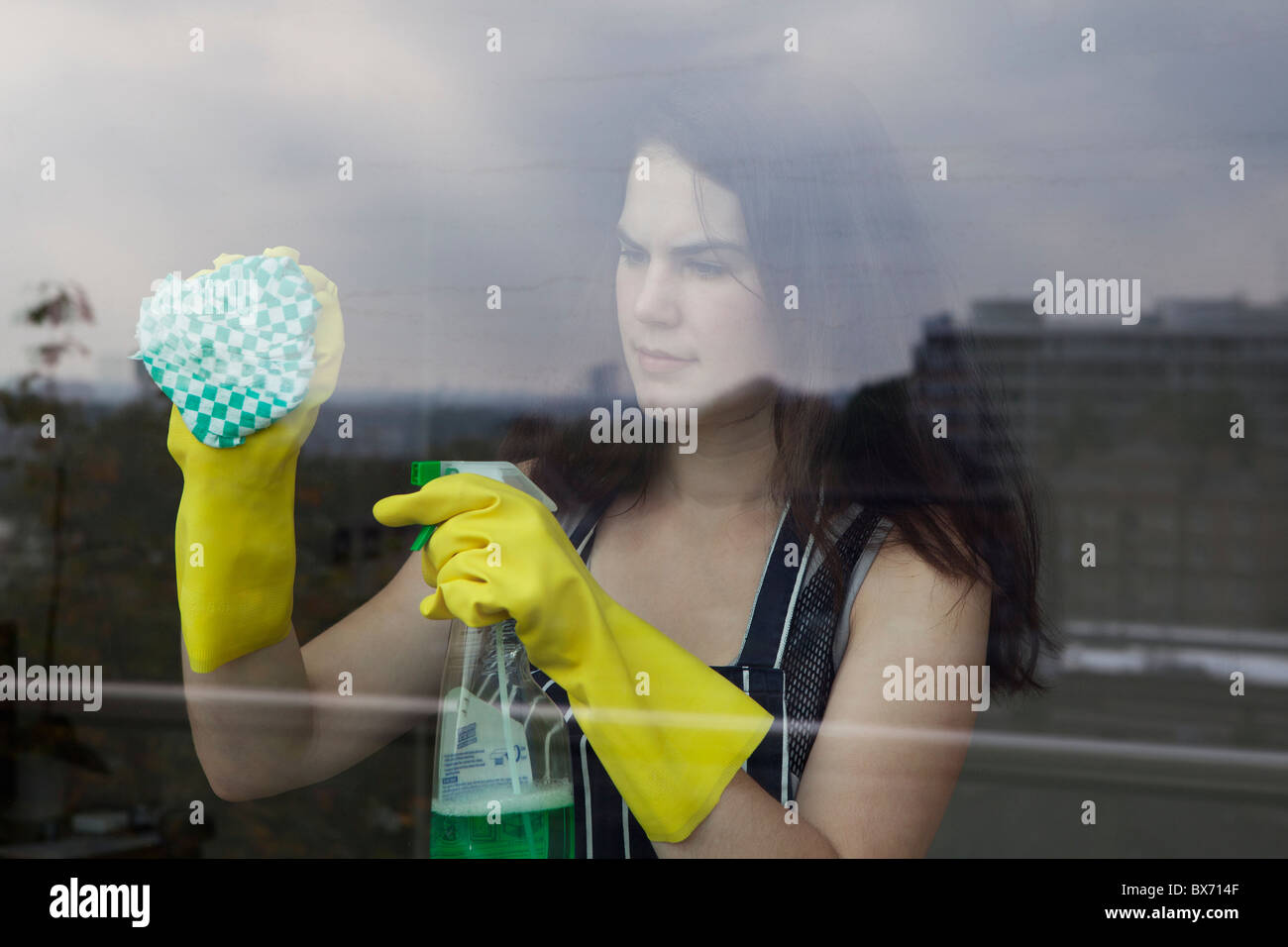 Woman cleaning window Stock Photo - Alamy