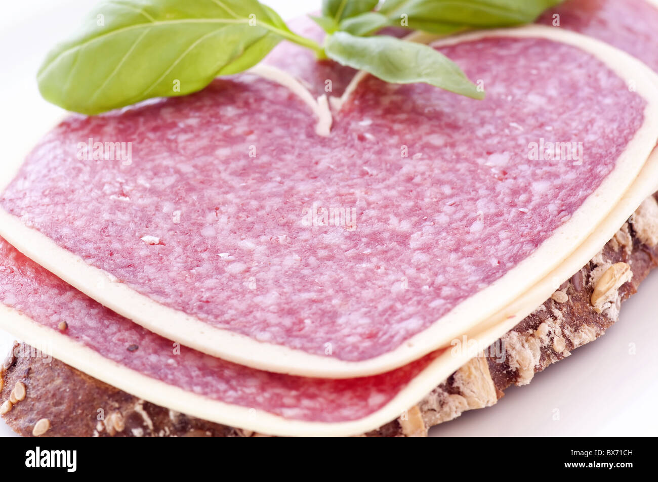 Heart-shaped salami on farmhouse bread as closeup Stock Photo - Alamy