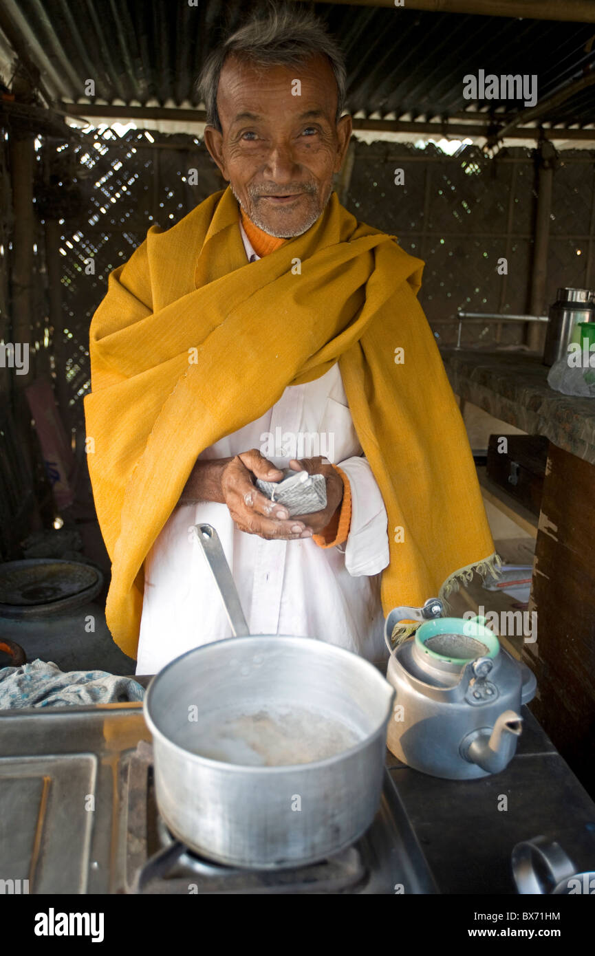 Village chai wallah (teamaker) makes the first brew of the day, Kurua ...