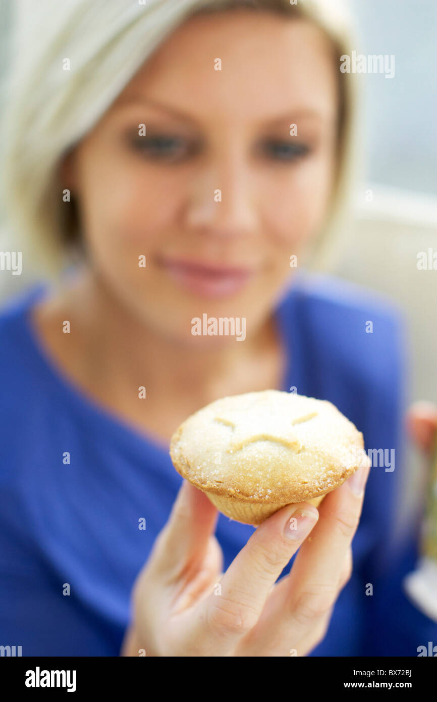 Woman eating mince pies Stock Photo - Alamy