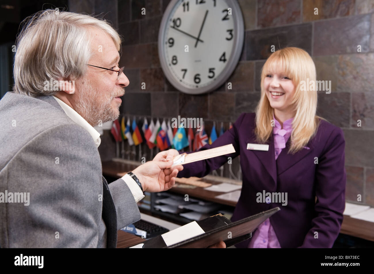 Businessman checking in at the reception desk Stock Photo - Alamy