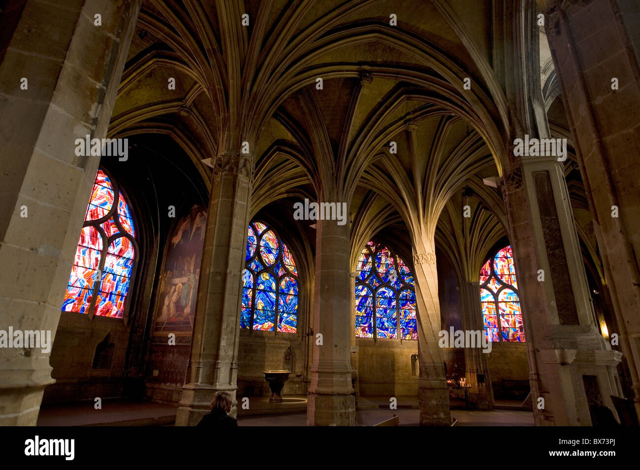 vaulted ceiling, gothic arches and stained-glass windows inside st ...