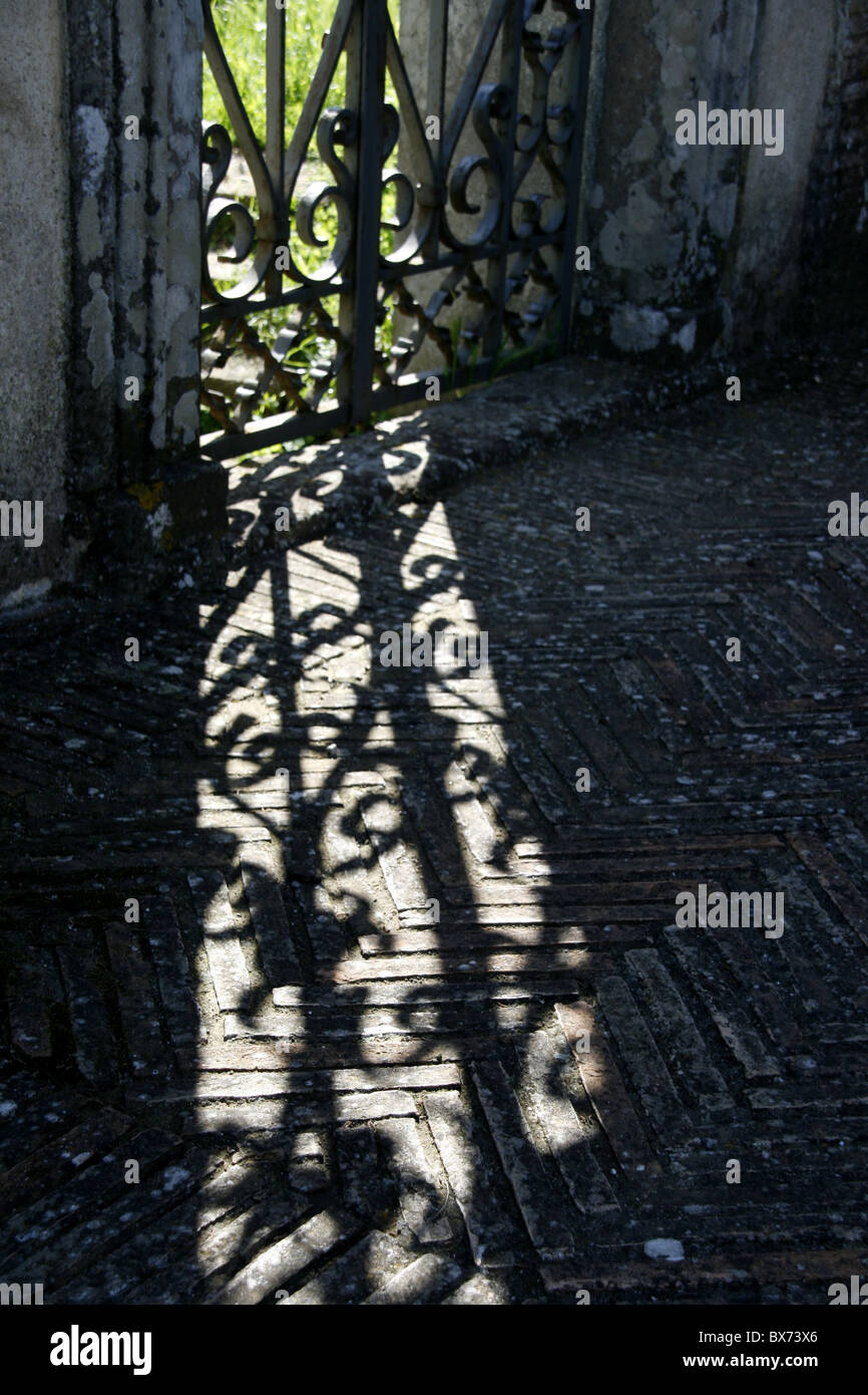 old gate shadow on street road Stock Photo - Alamy