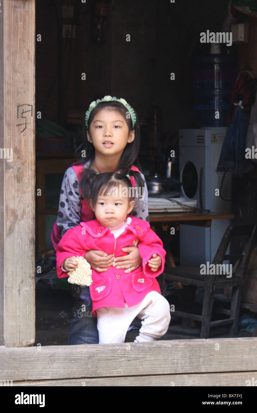 Two young Chinese girls in doors of Hutong house Stock Photo - Alamy