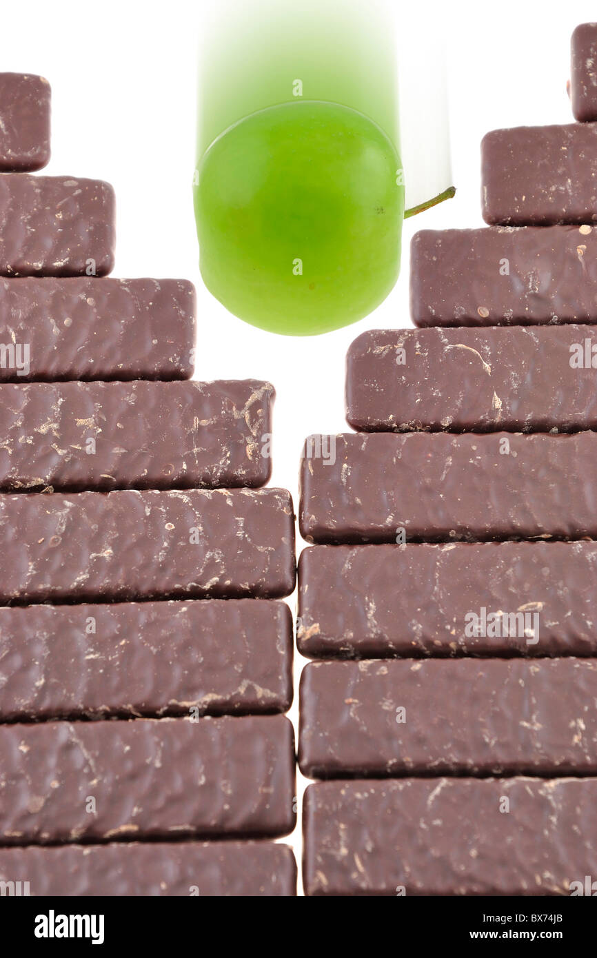 Food metaphor with apple and candies Stock Photo - Alamy