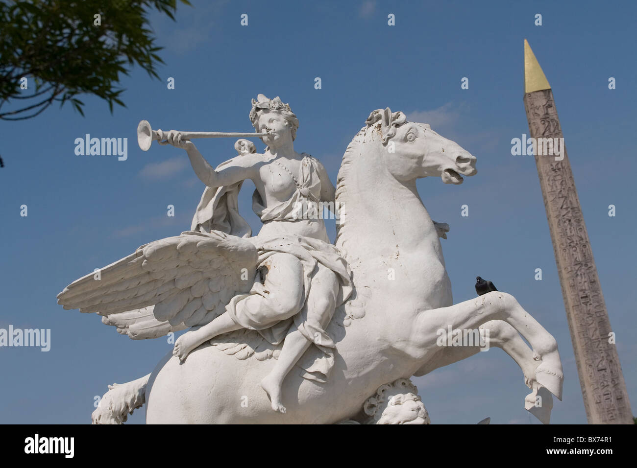 statue of a horse and an angel, and the egyptian obelisk at place de la ...