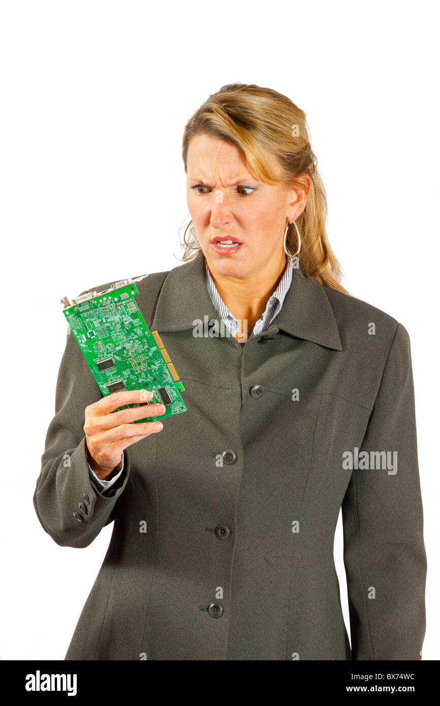 Woman stares at a computer part confused Stock Photo - Alamy