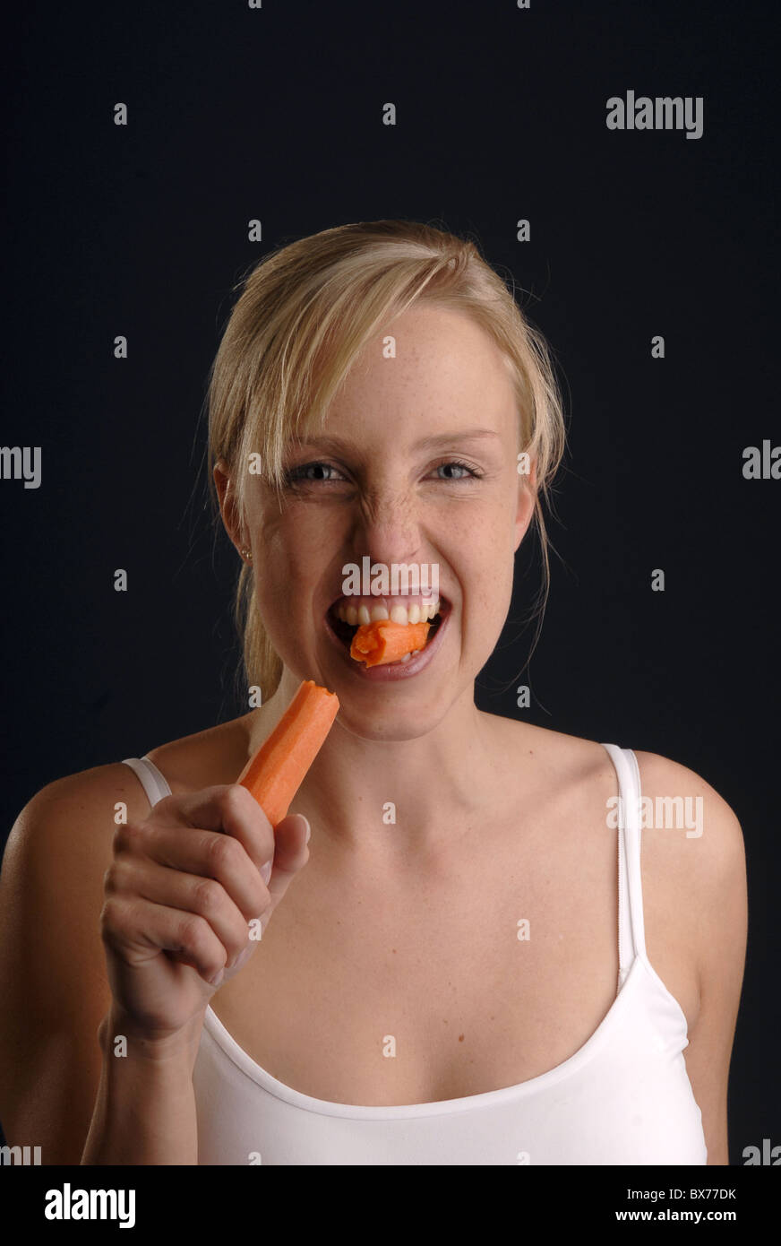 woman eat a carrot Stock Photo - Alamy