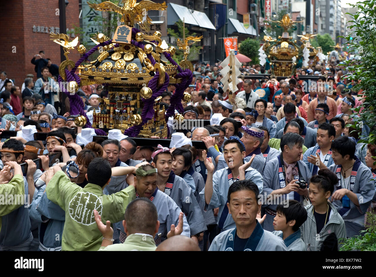 A mikoshi (portable shrine) being carried through the streets during ...