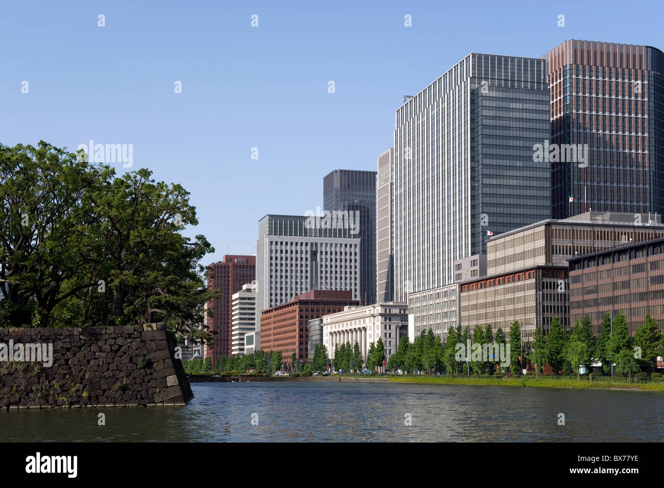 Modern high-rise office buildings lining the old Edo Castle moat in the ...