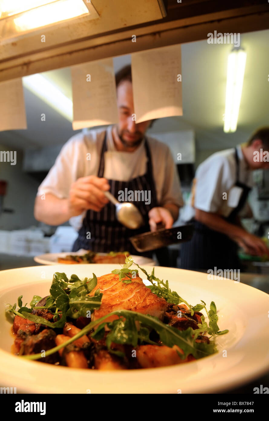 The Chef Stephen Terry adds a garnish and dressing to a fish meal at ...