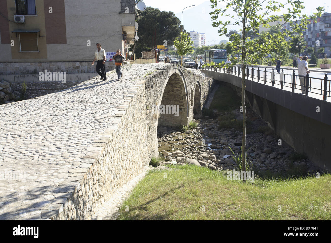 People walking over the Tanner's bridge, an Ottoman stone footbridge in ...