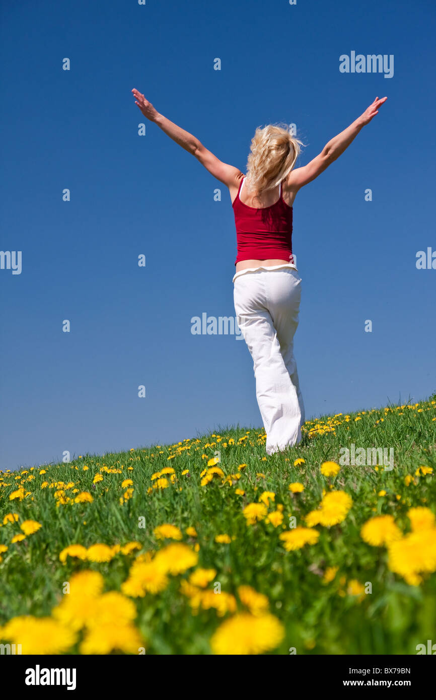 young woman having fun on a flowery meadow Stock Photo - Alamy
