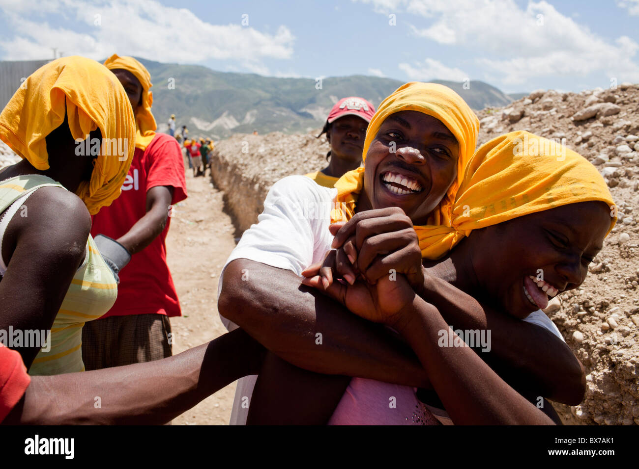 Members of a work crew digging a drainage ditch along the edges of the ...