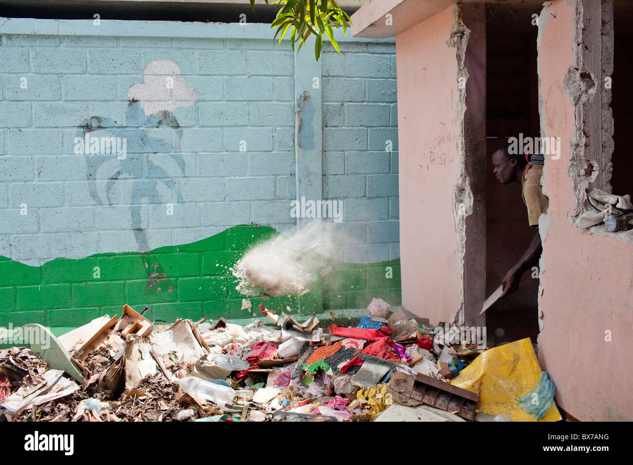 A man clears rubble from a small room at a former school on July 7 ...