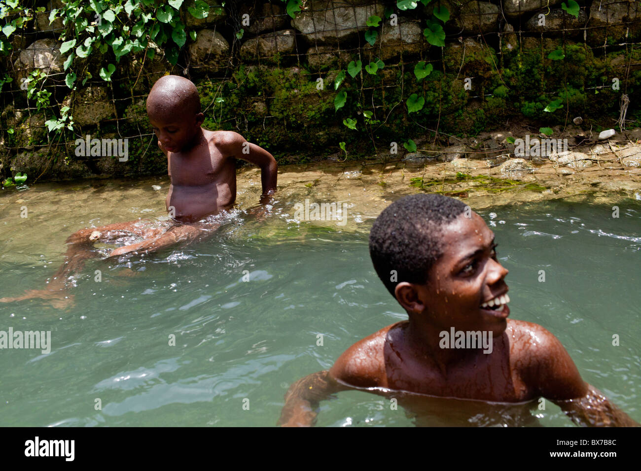 Boys swim in a river on July 16, 2010 in Gador, Haiti Stock Photo - Alamy