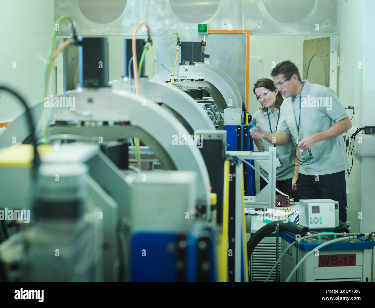 Scientists with particle accelerator Stock Photo - Alamy