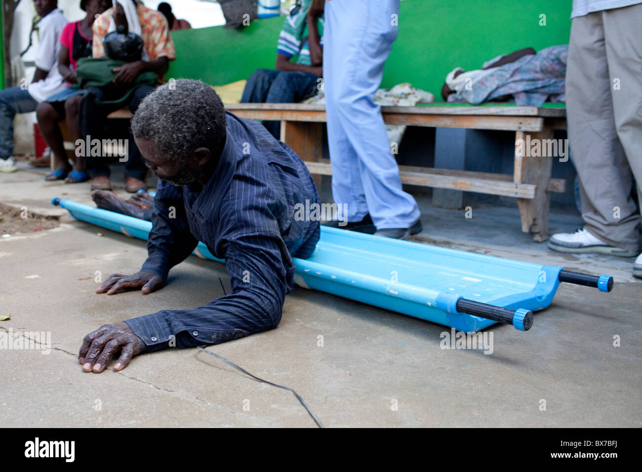 A cholera patient rolls over to vomit after being brought to the ...