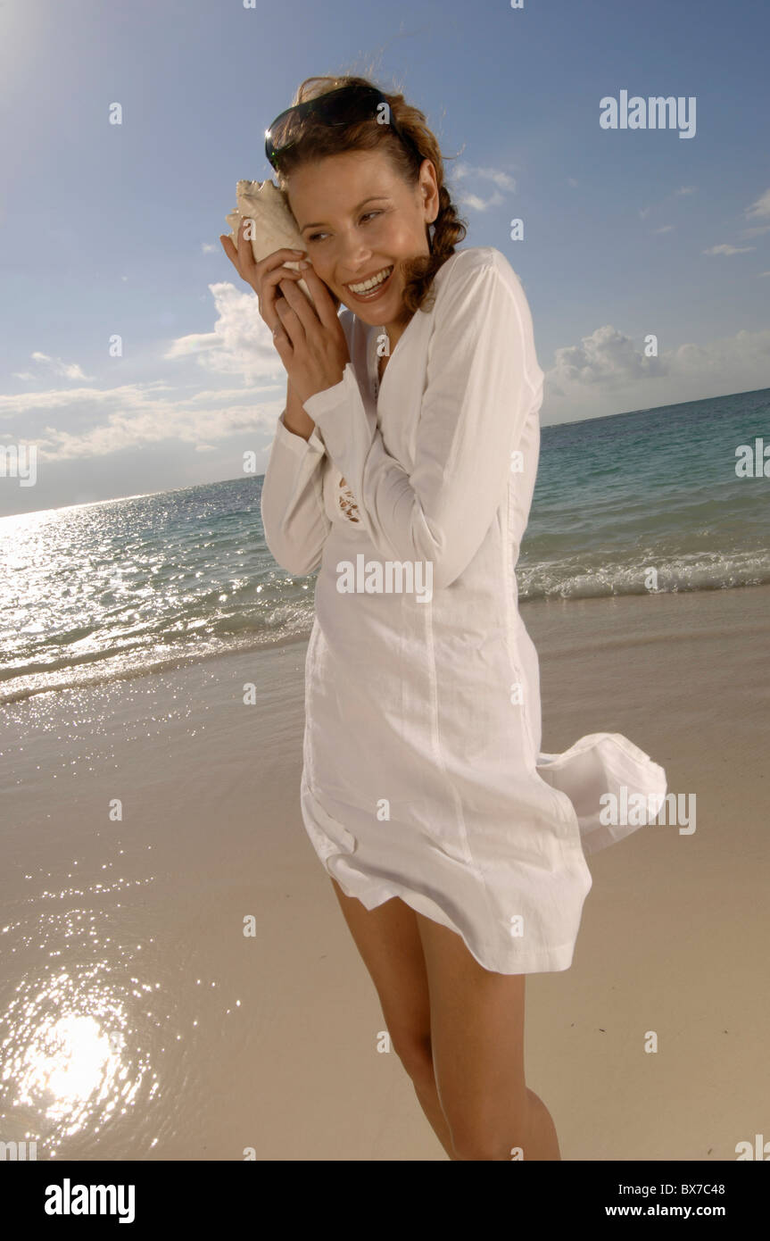 Woman blowing shell hi-res stock photography and images - Alamy