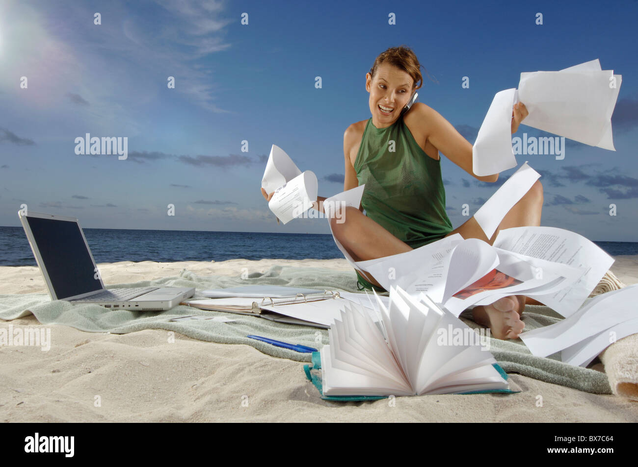 Woman working on beach Stock Photo - Alamy