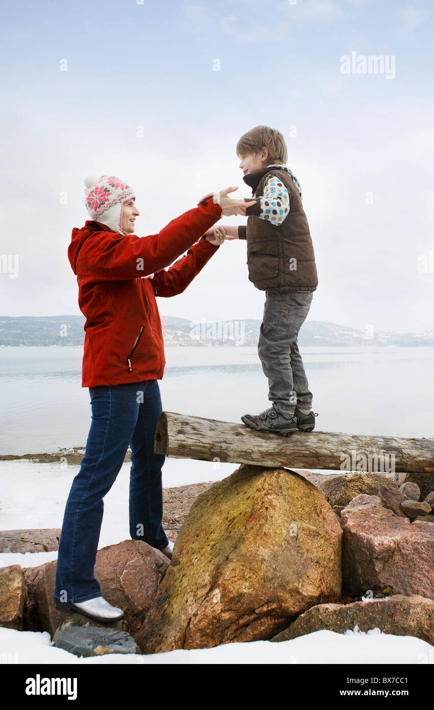 Mother helping child coat hi-res stock photography and images - Alamy