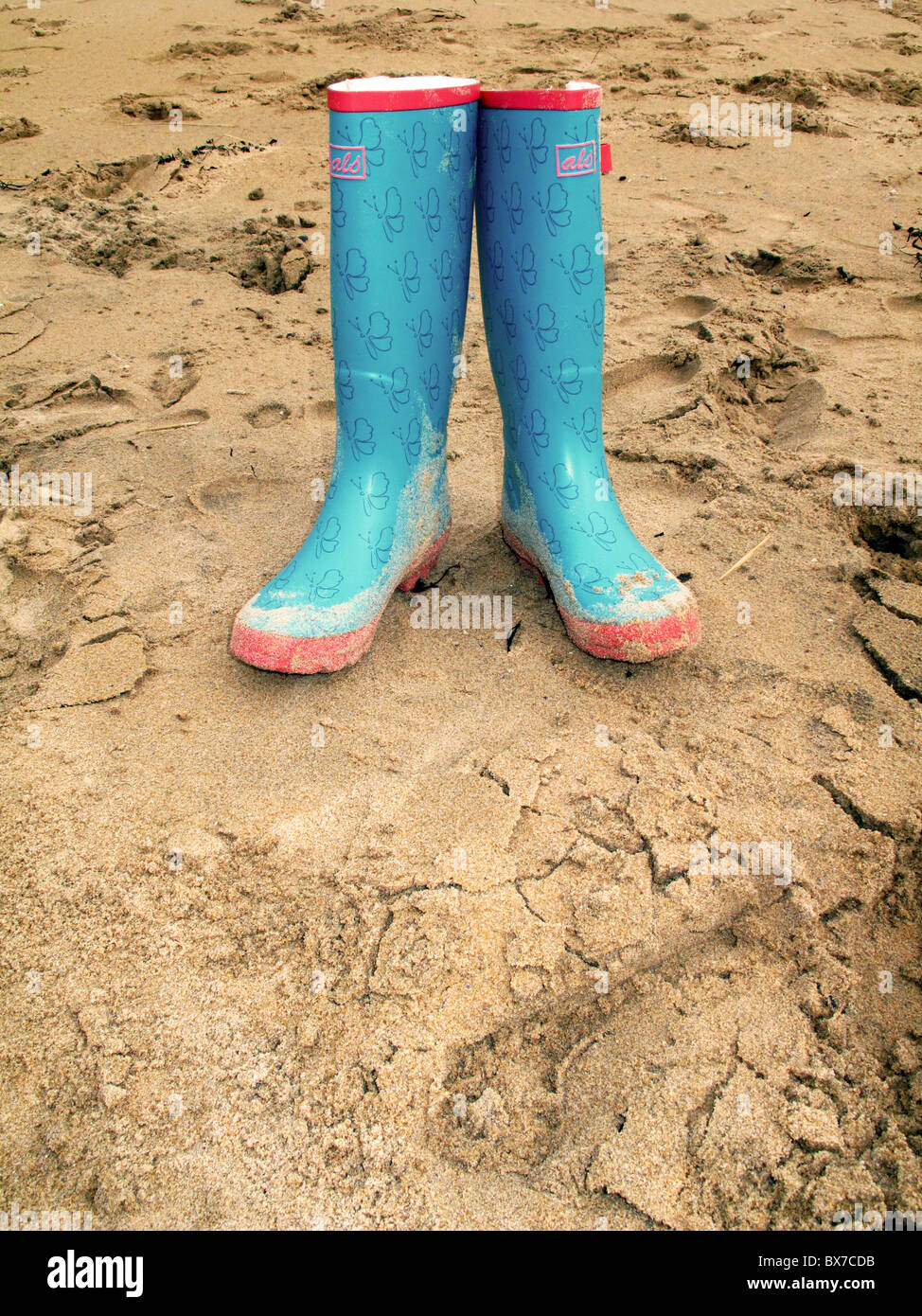 Pair of colored wellington boots on beach Stock Photo - Alamy