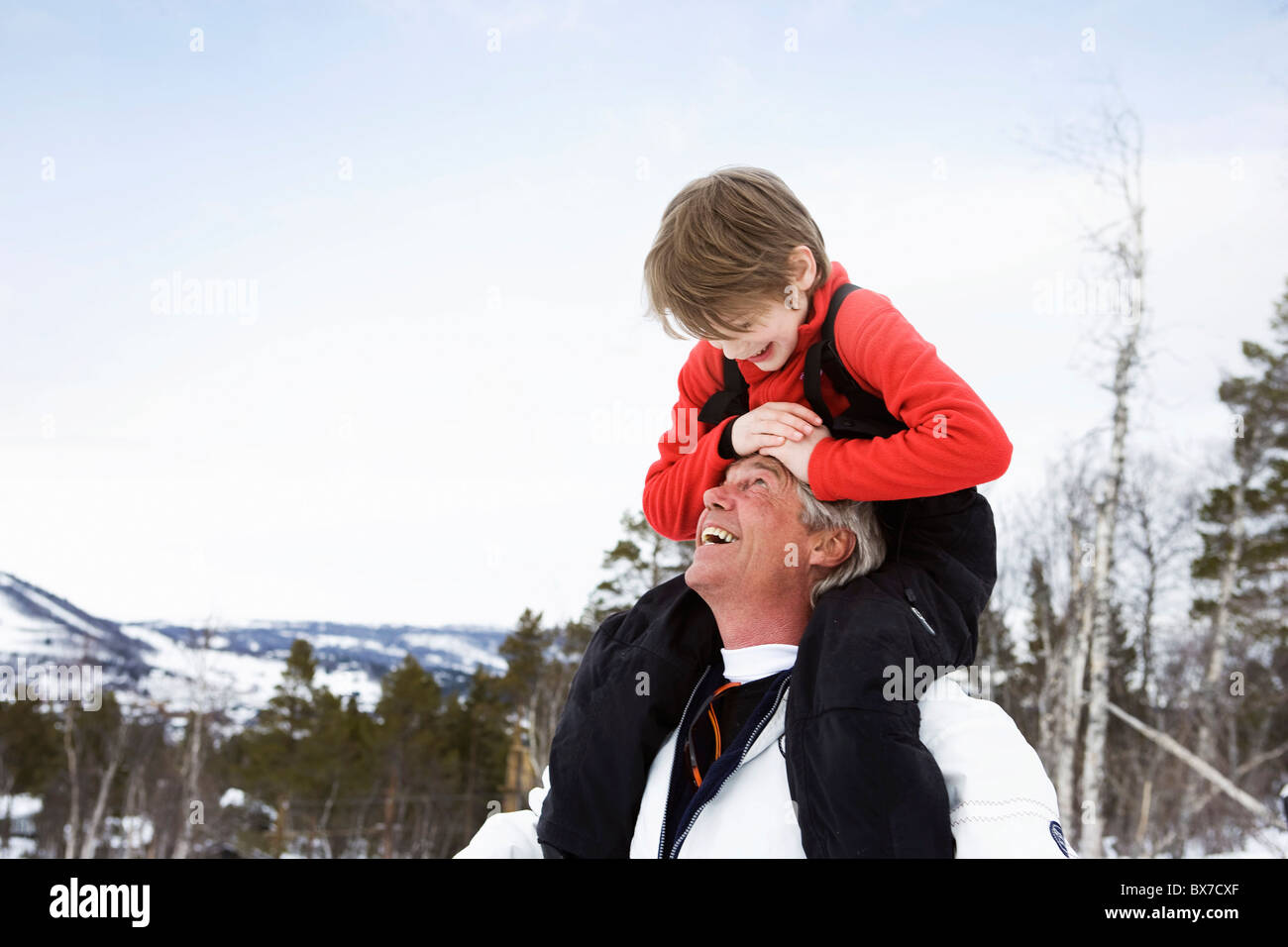 Grandson and grandfather smiling Stock Photo - Alamy