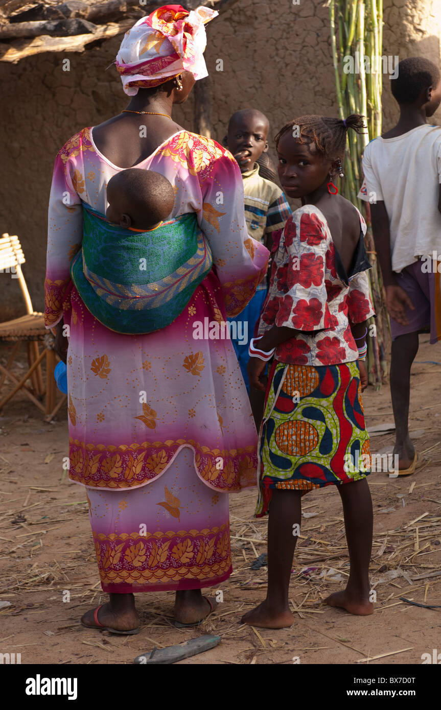 Mother and her children seen from the back on a market in Mali, West ...