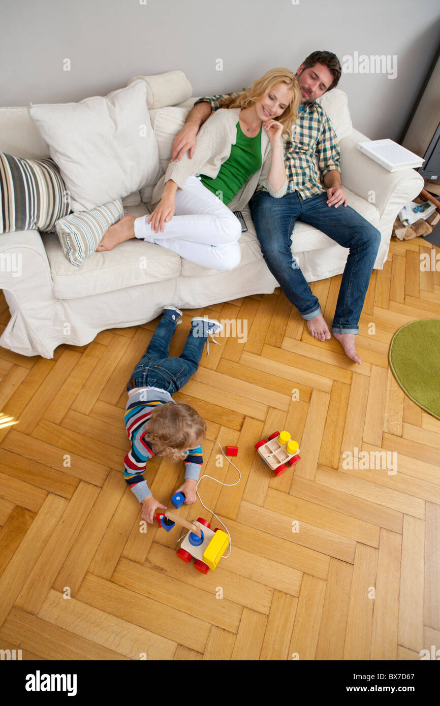 Family in their living room Stock Photo - Alamy