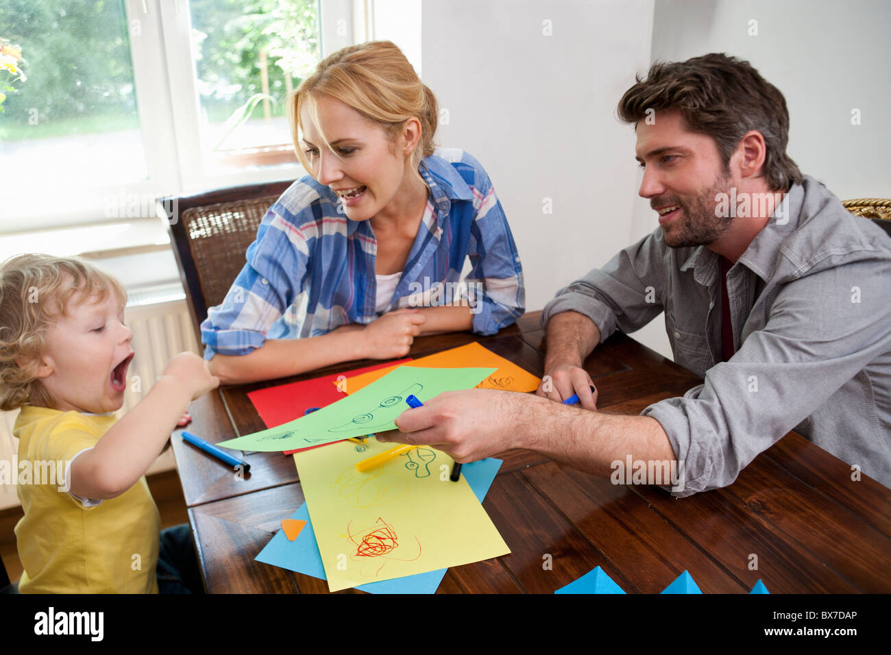 Family handcrafting on table Stock Photo - Alamy