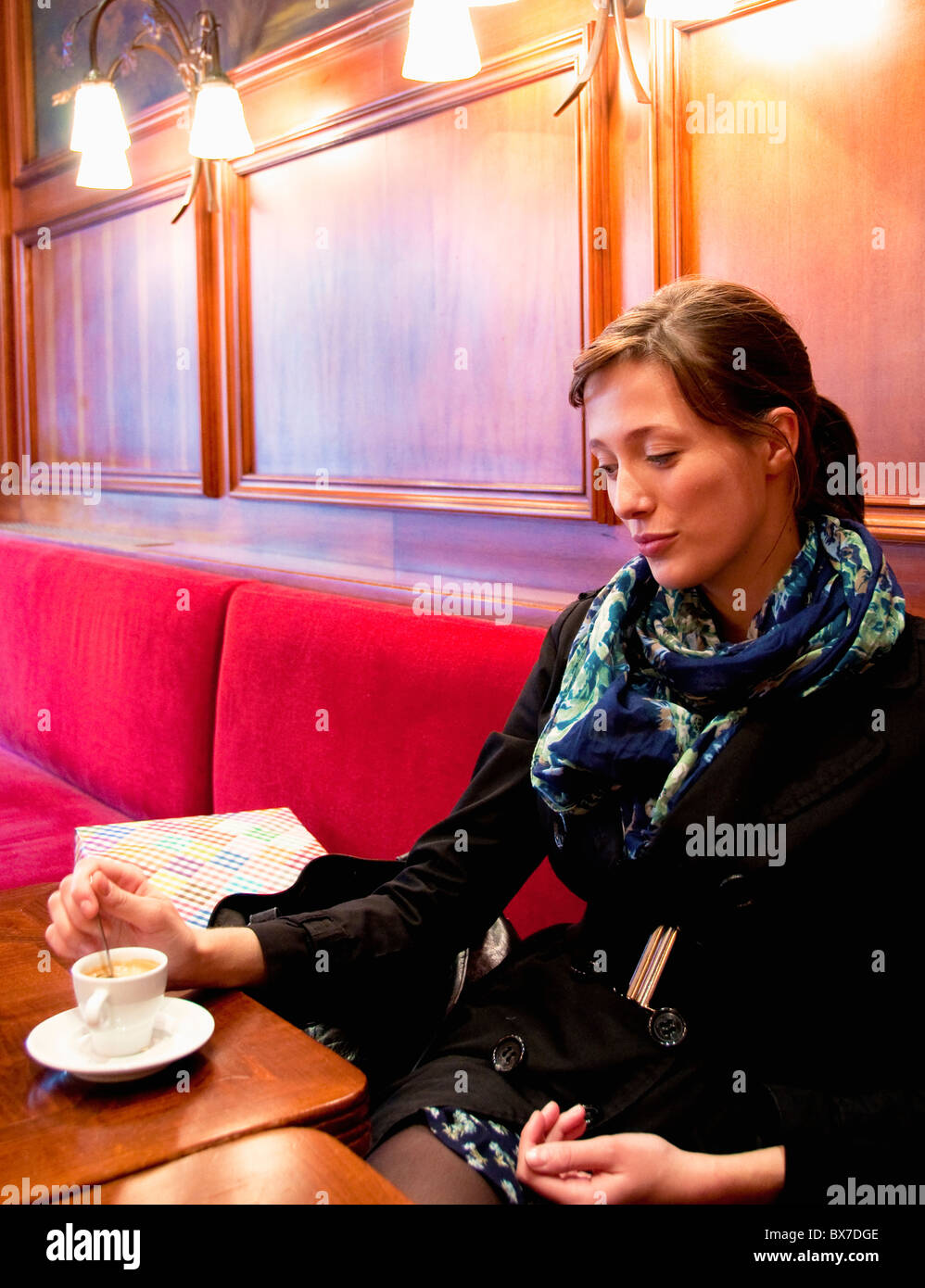 Woman stirs drink cafe hi-res stock photography and images - Alamy