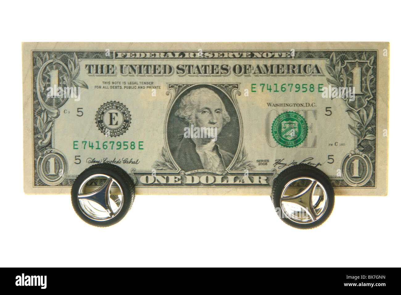 dollar bill on wheels Stock Photo - Alamy