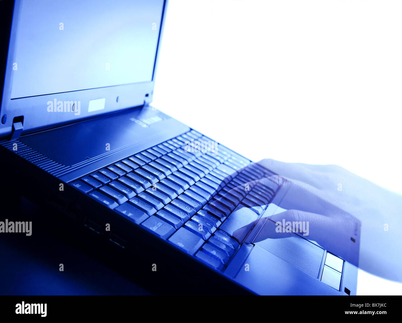 Ghostly hand typing on a laptop Stock Photo - Alamy