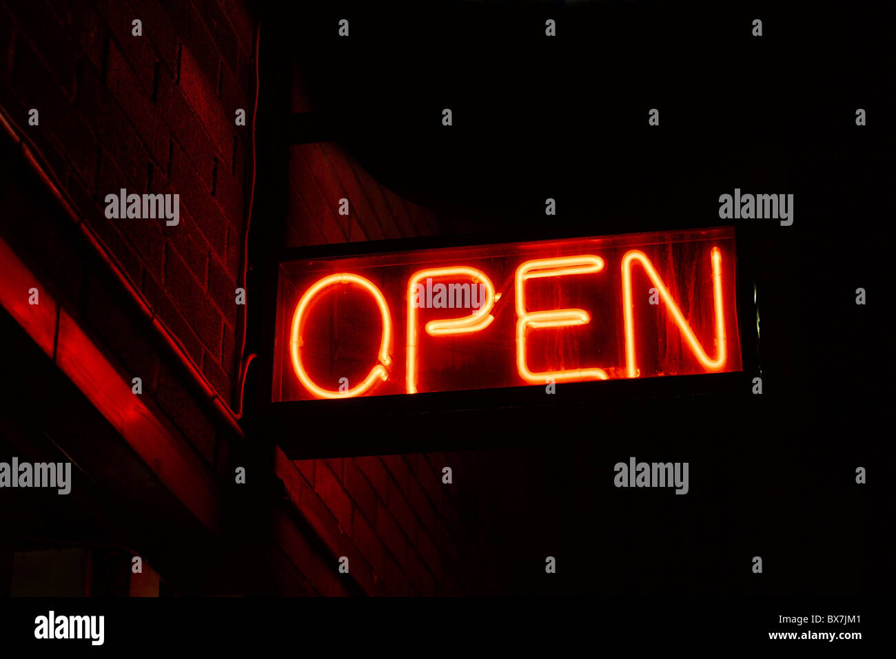 Red open neon sign glowing in the night Stock Photo - Alamy