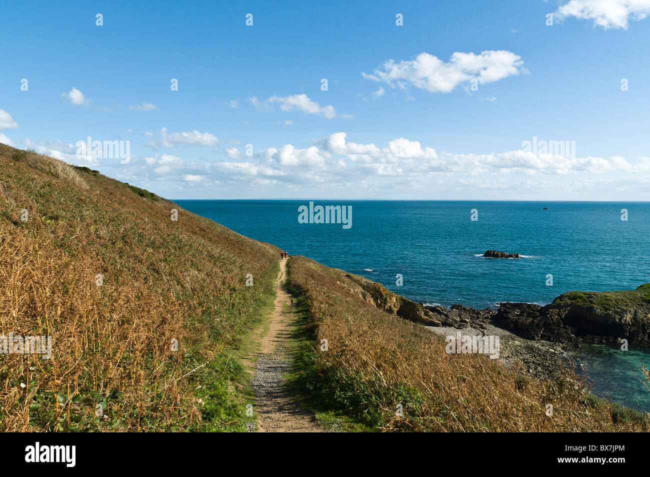 dh HERM GUERNSEY People walking on Herm footpath around islands south ...