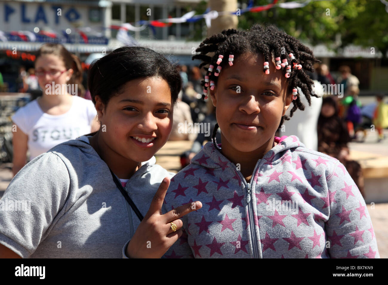 Two girls giving the V-sign during neighbourhood festivities in ...