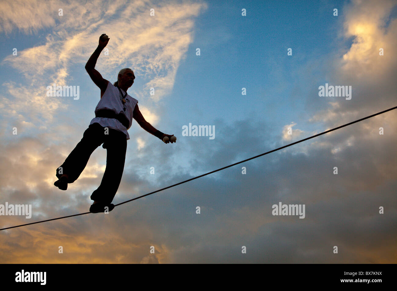 Street performer Will Soto performs his tightrope act during the Sunset ...