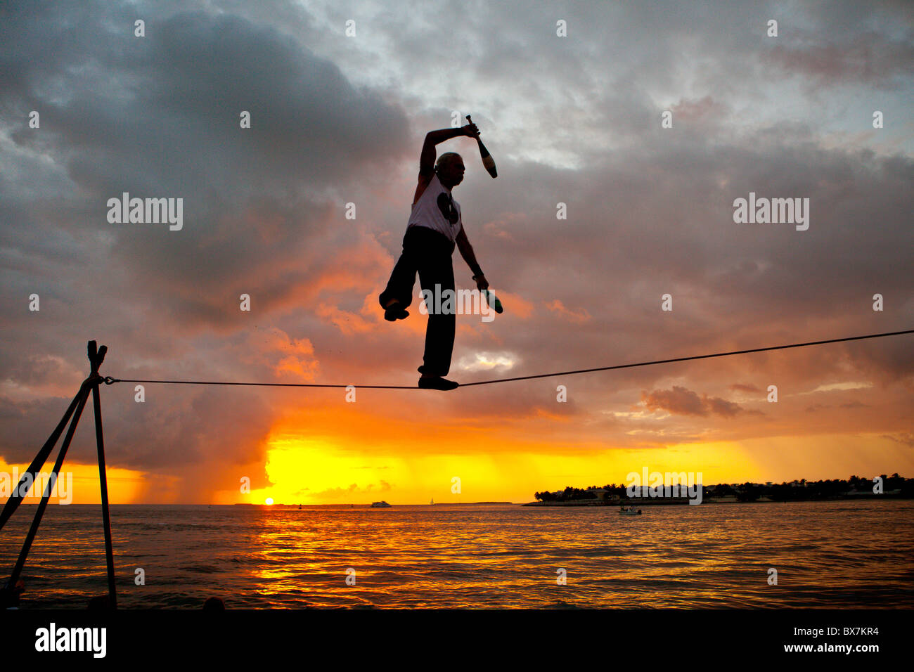 Street performer Will Soto performs his tightrope act during the Sunset ...